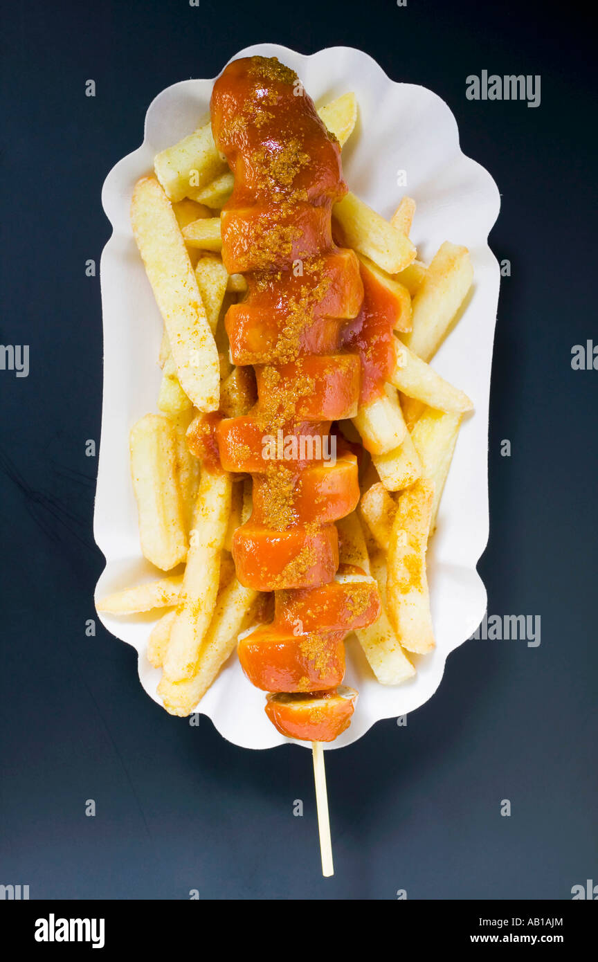 Currywurst sausage with ketchup curry powder chips in paper dish ...