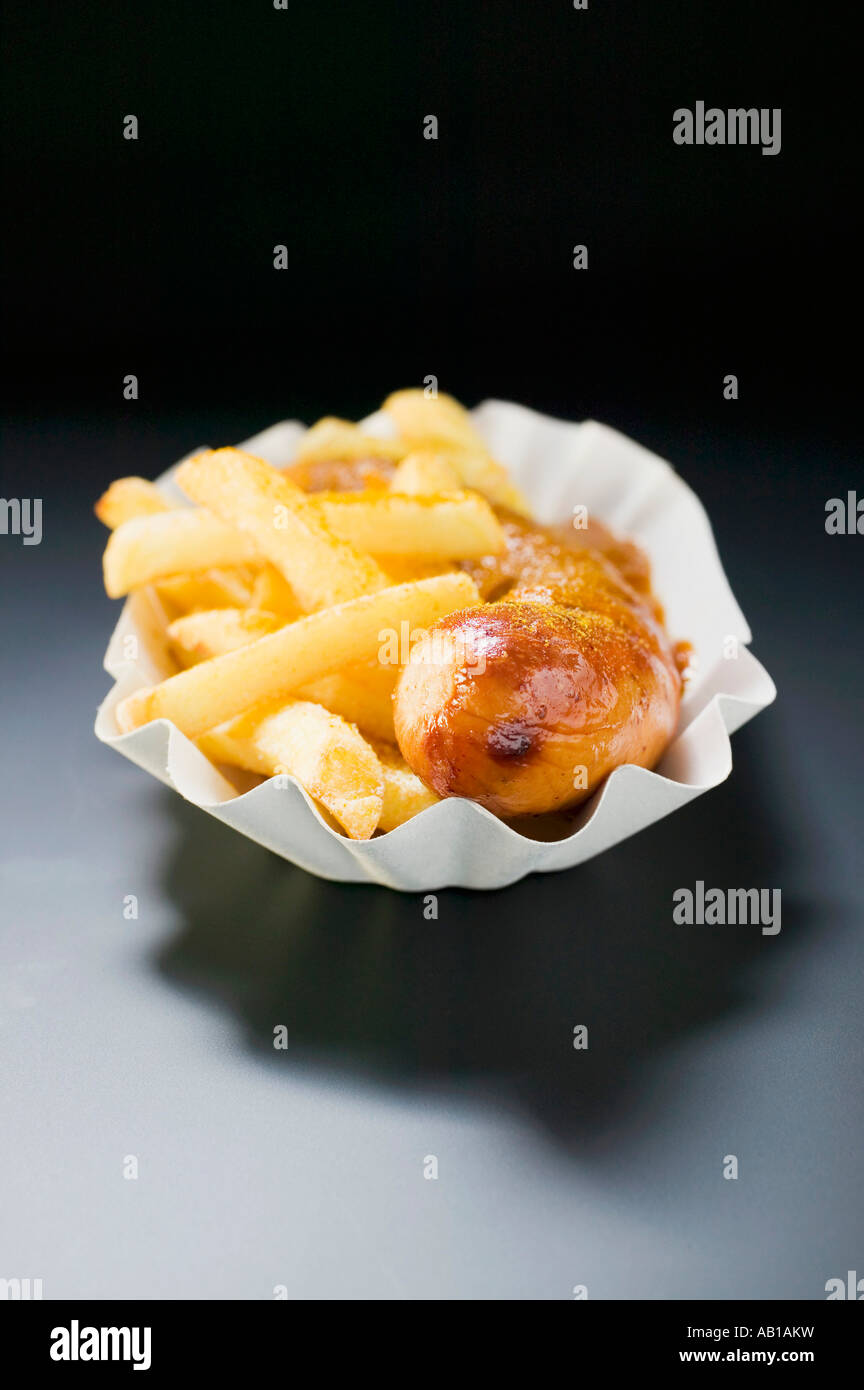 Currywurst sausage with ketchup curry powder chips in paper dish ...