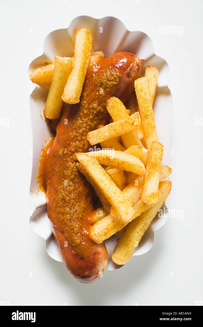 Currywurst sausage with ketchup curry powder chips in paper dish ...