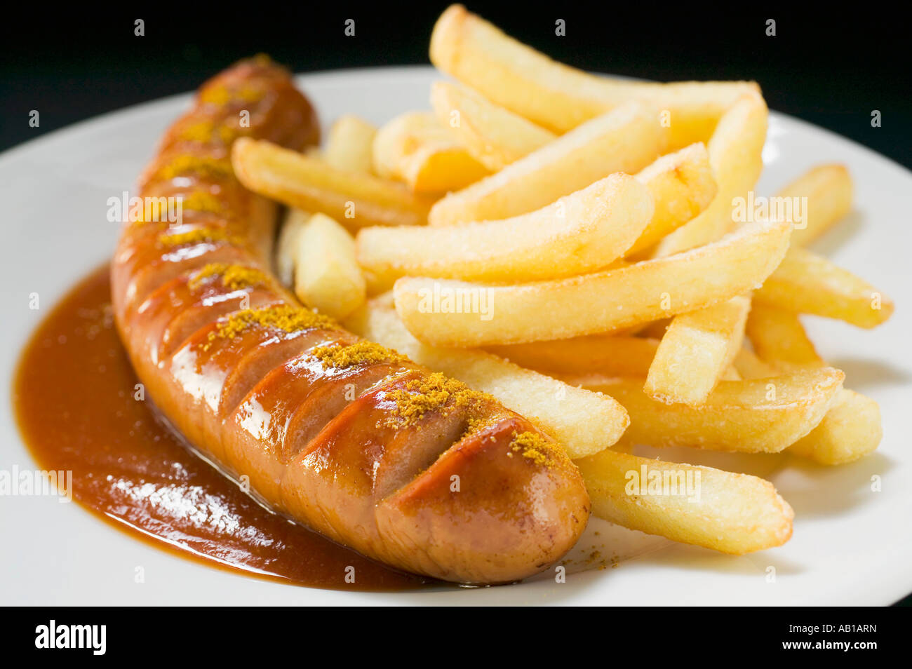 Currywurst sausage with ketchup curry powder chips on plate ...