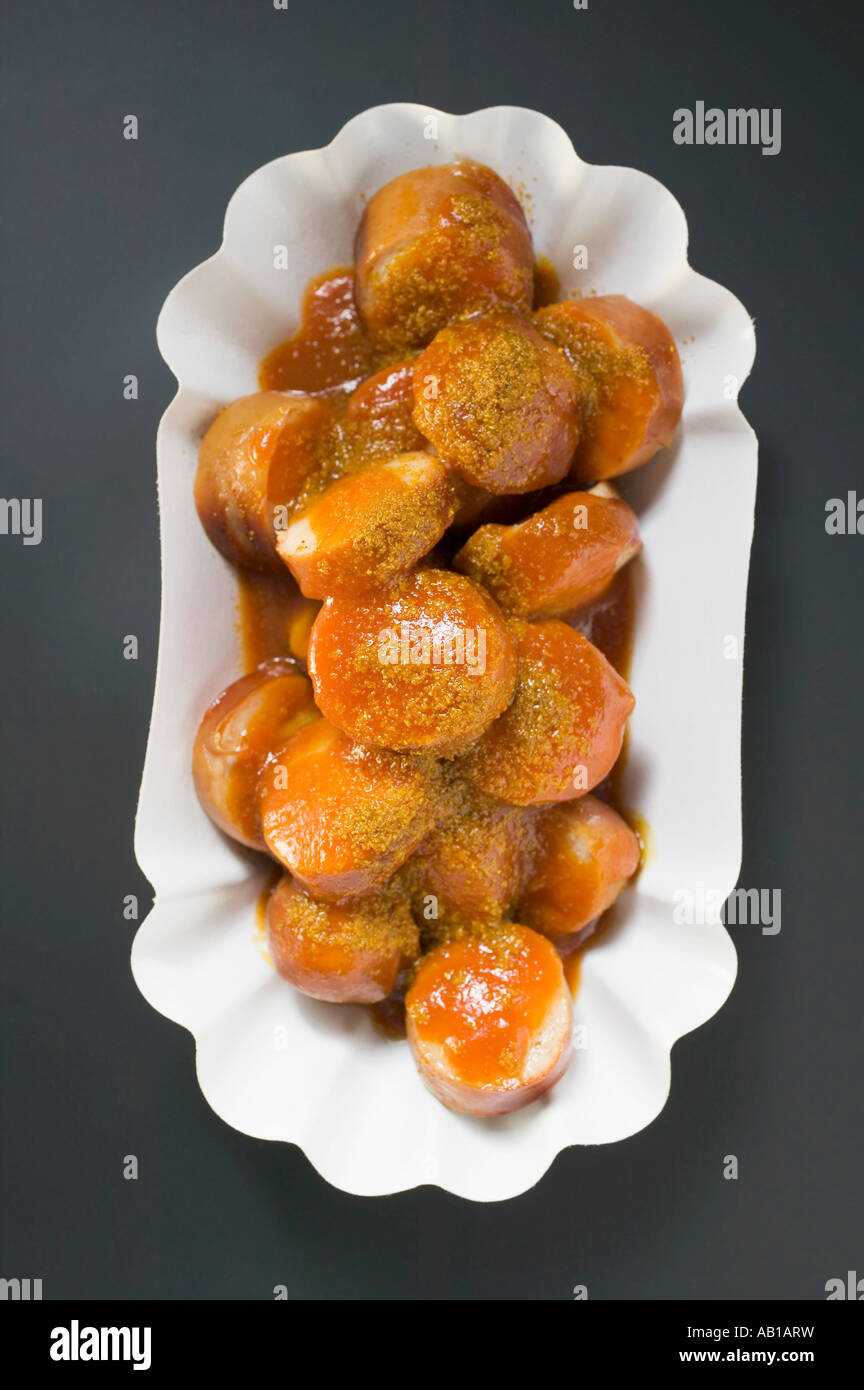 Currywurst sausage with ketchup curry powder in paper dish overhead ...