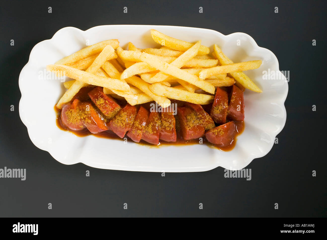 Currywurst sausage with ketchup curry powder chips overhead ...