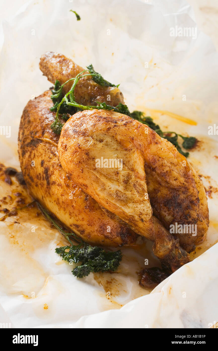 Half a roast chicken with parsley on paper FoodCollection Stock Photo ...