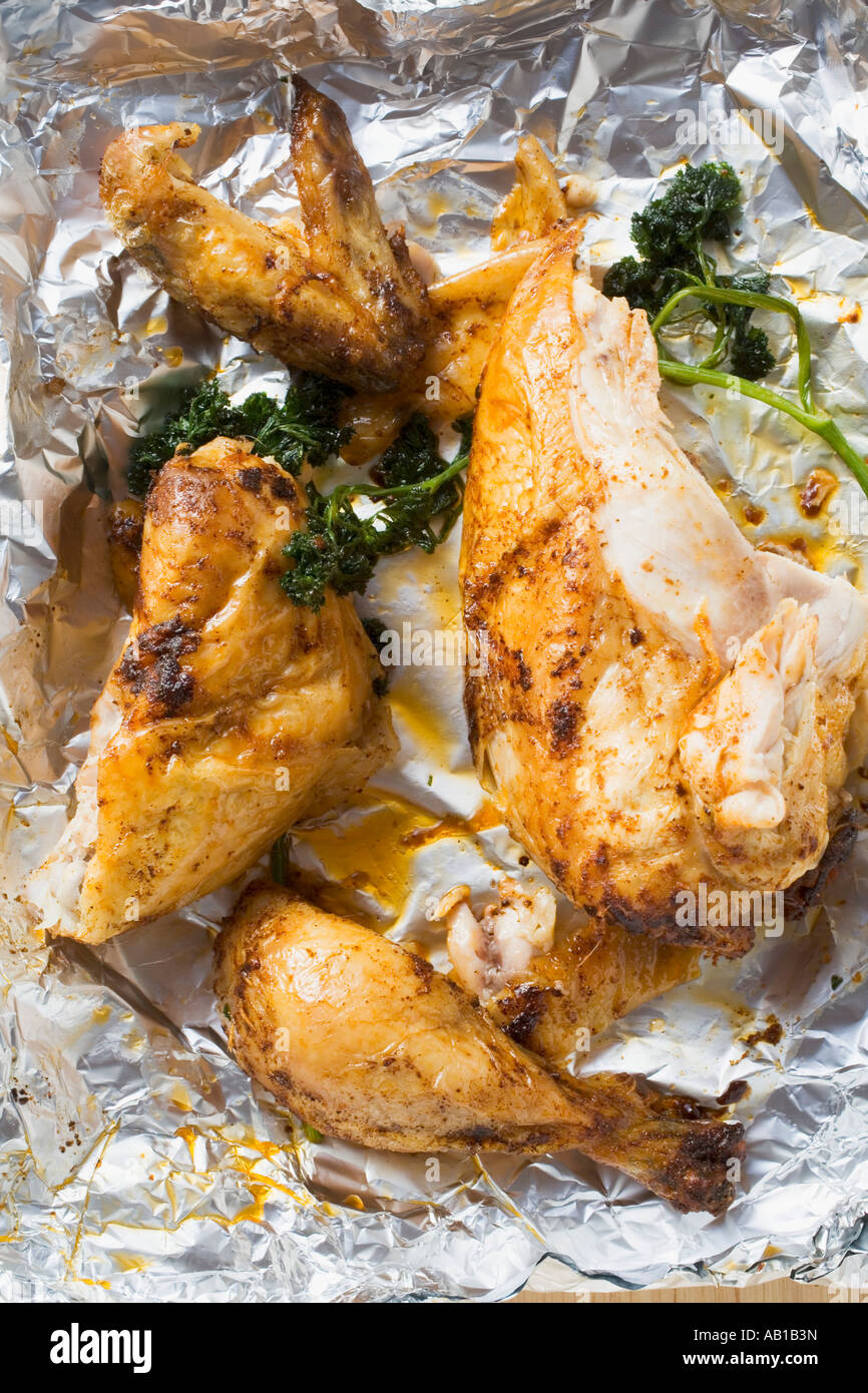 Pieces of roast chicken in aluminium foil FoodCollection Stock Photo ...