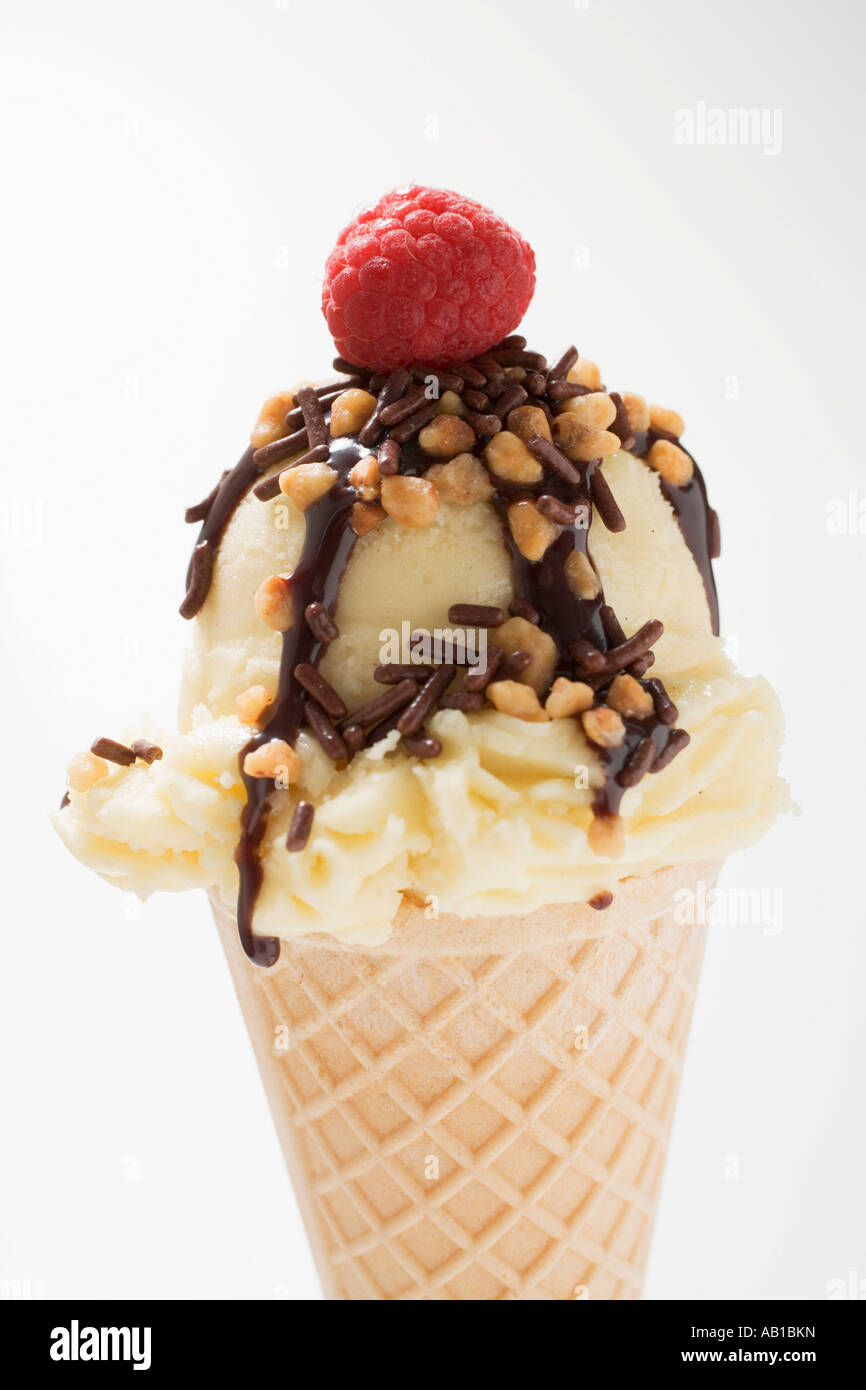Cone of nut ice cream with chocolate sauce and raspberry FoodCollection ...