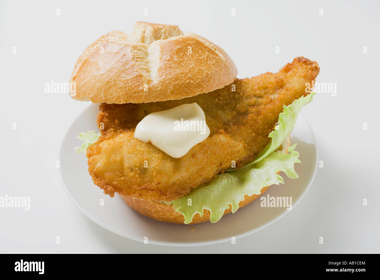 Breaded fish fillet and mayonnaise in bread roll FoodCollection Stock ...