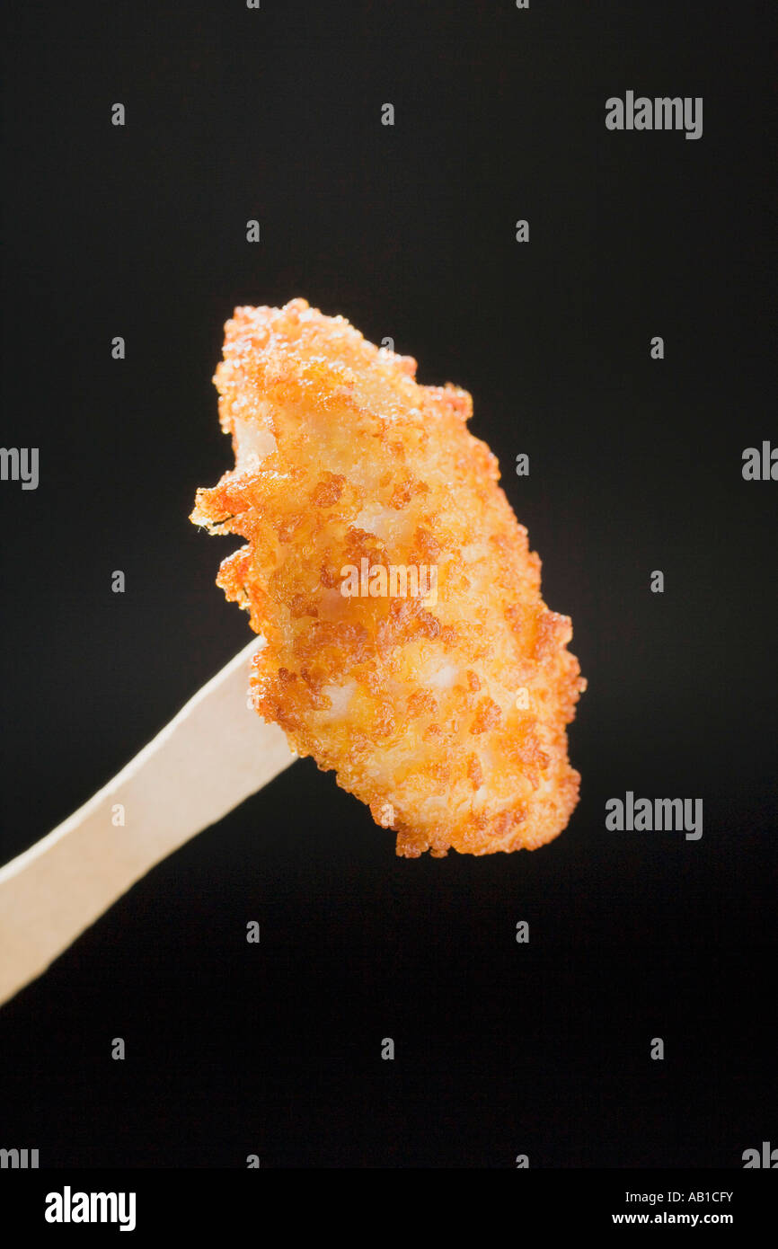 A chicken nugget on a wooden fork FoodCollection Stock Photo - Alamy