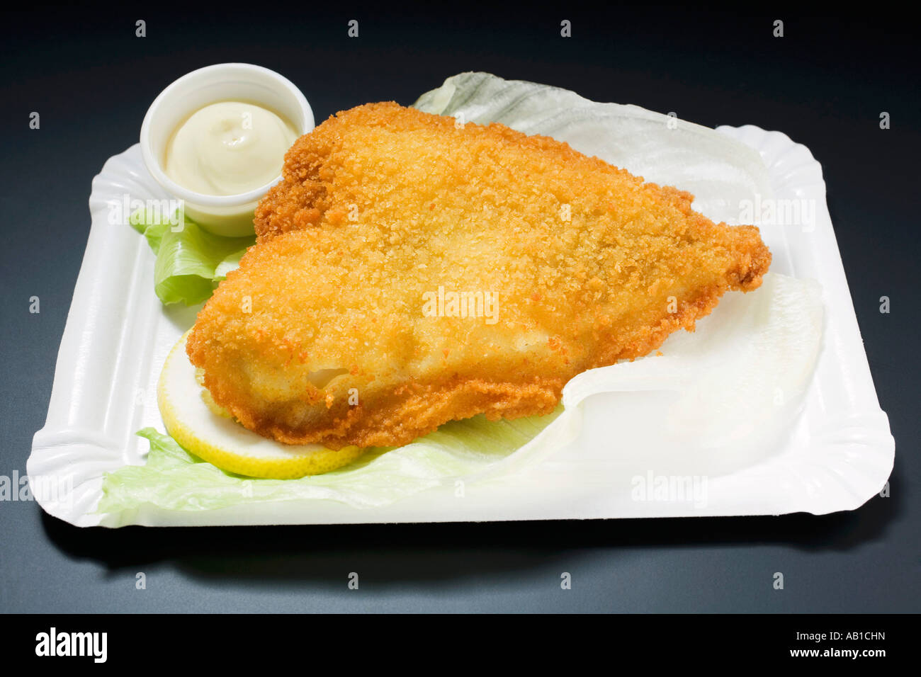 Breaded fish fillet with mayonnaise on paper plate FoodCollection Stock ...