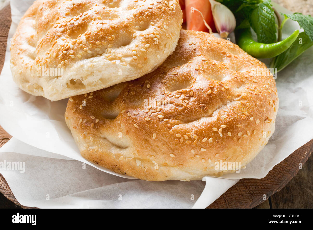 Sesame flatbread tomato mint chilli garlic on paper FoodCollection ...