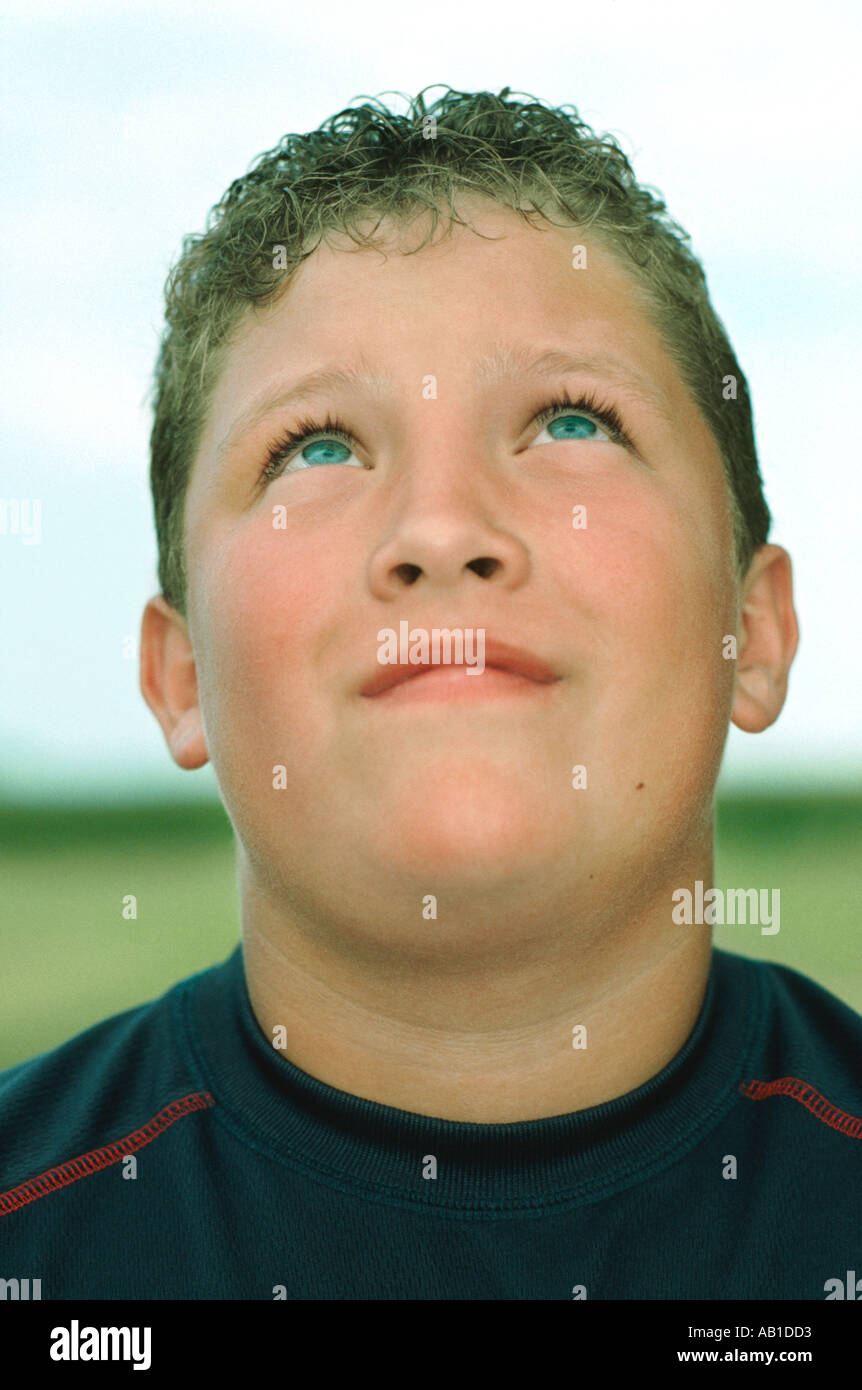 Boy in field looking up Stock Photo - Alamy