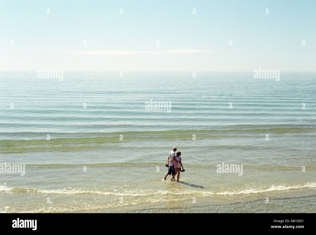 Couple walking in shallow water hi-res stock photography and images - Alamy