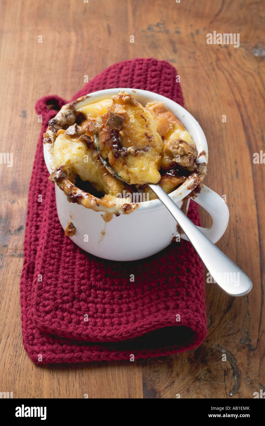 Chocolate bread and butter pudding in cup with spoon FoodCollection ...
