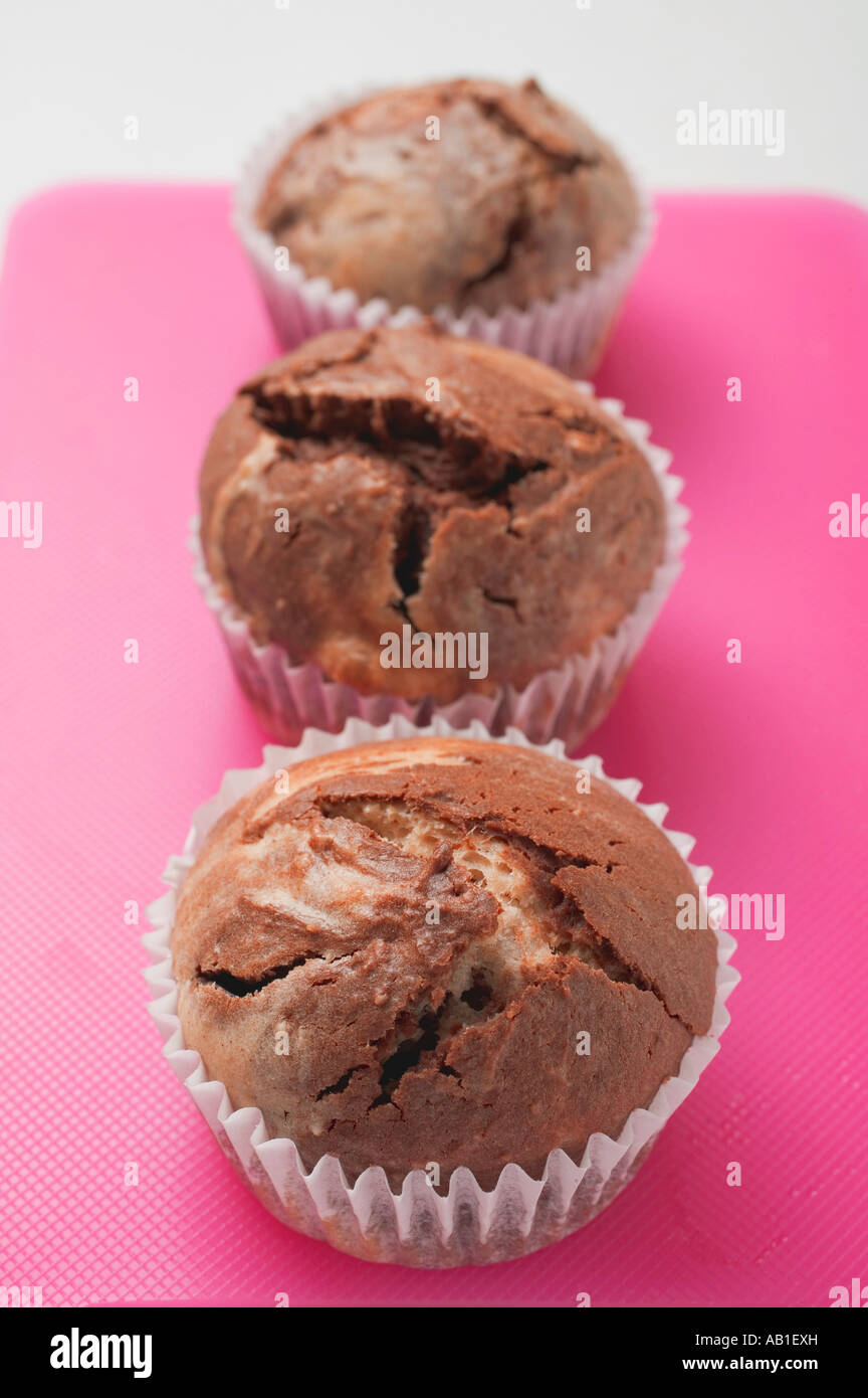 Three chocolate and vanilla muffins in paper cases FoodCollection Stock ...