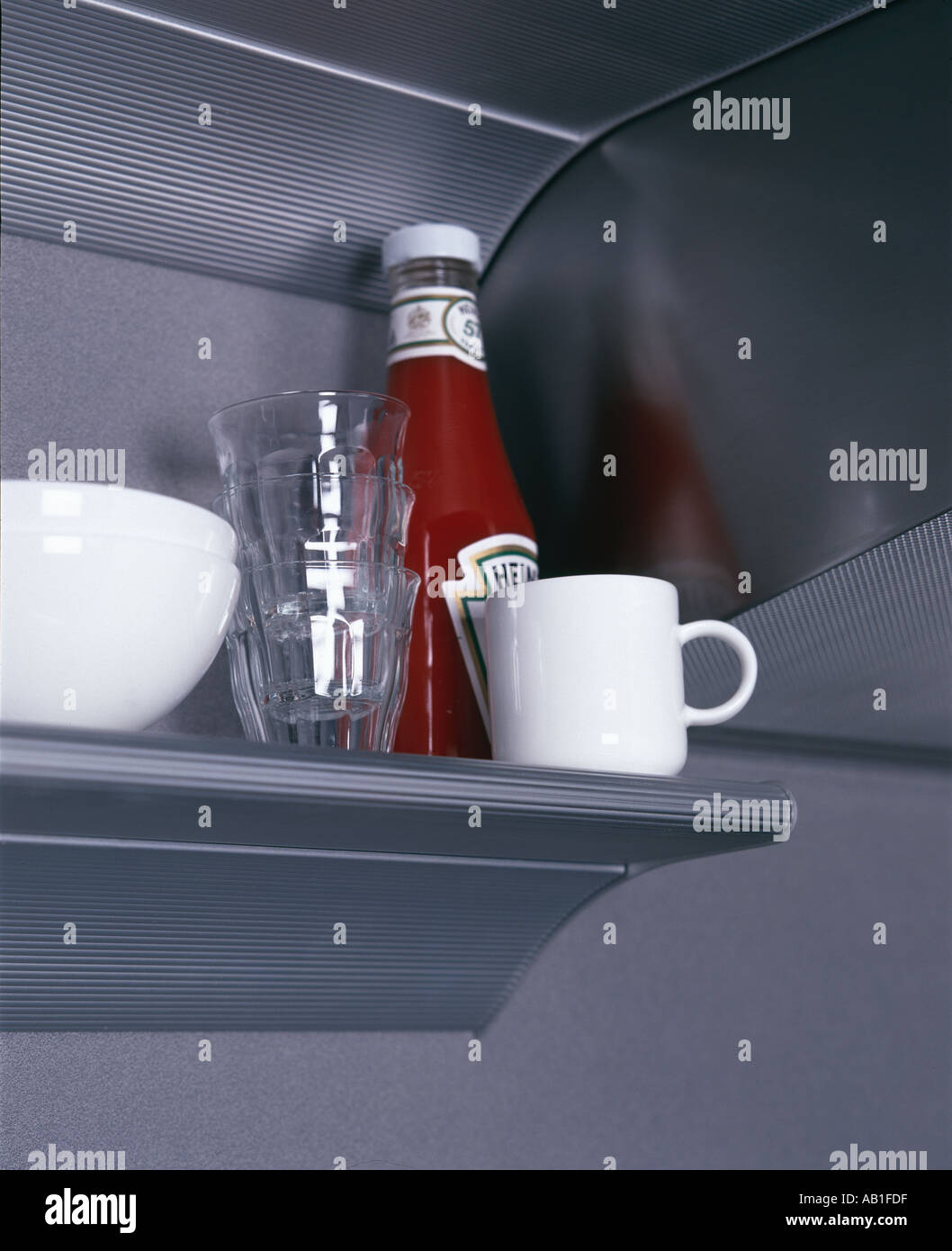 Modern metal shelf with tomato ketchup glasses as mug Stock Photo - Alamy