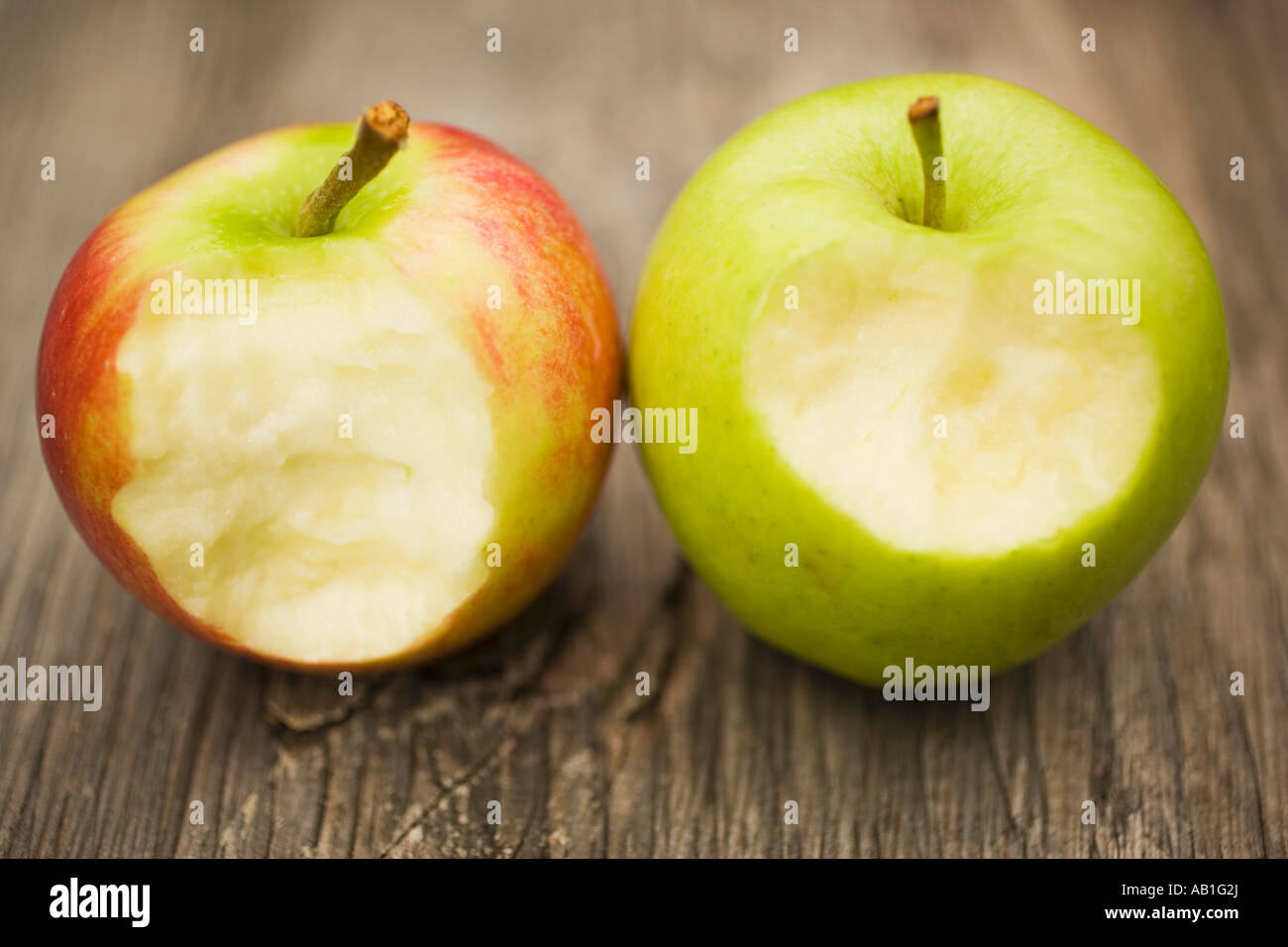 Two apples with bites taken on wooden background FoodCollection Stock ...
