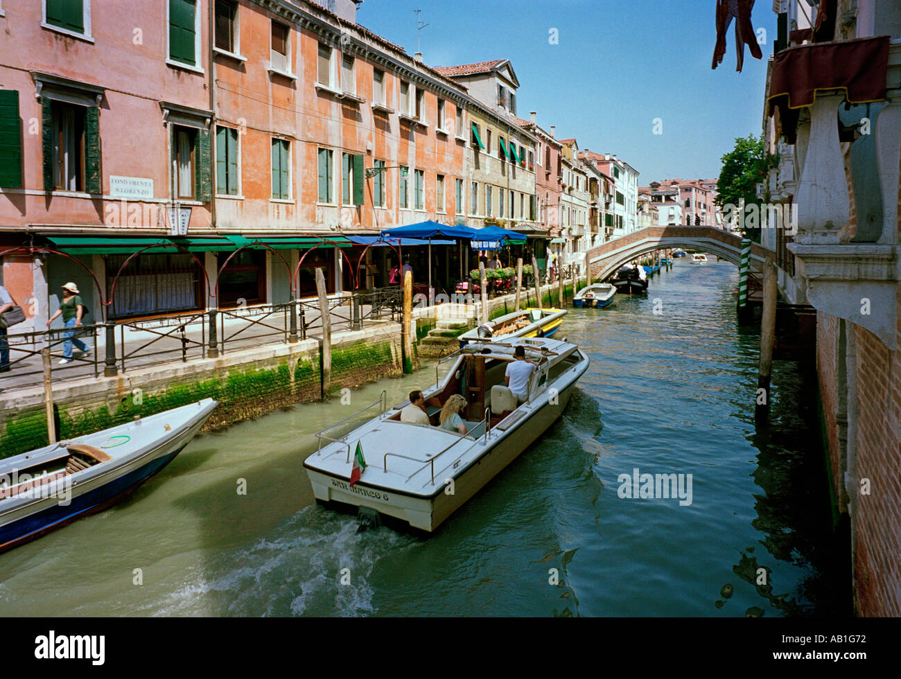 A typical scene in Venice with boats bridges ancient buildings and ...