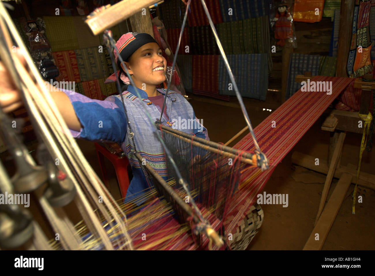 Young Koho woman weaving scarf in minority village Lang Dinh An or ...