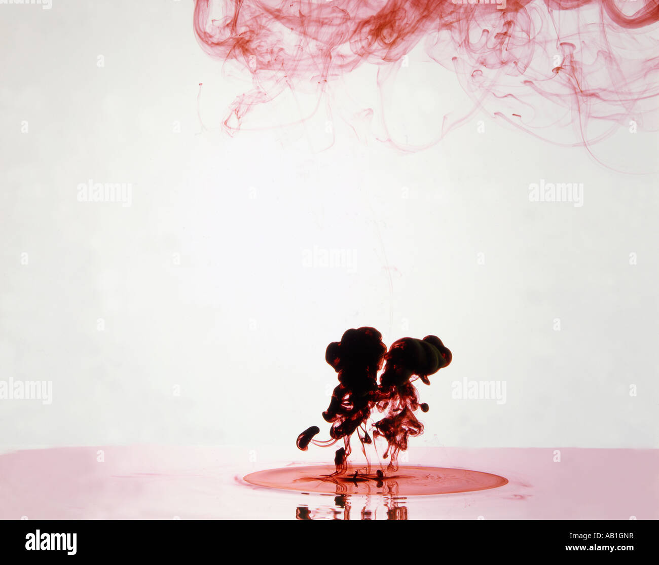 red ink drops in water clouds of colour Stock Photo - Alamy