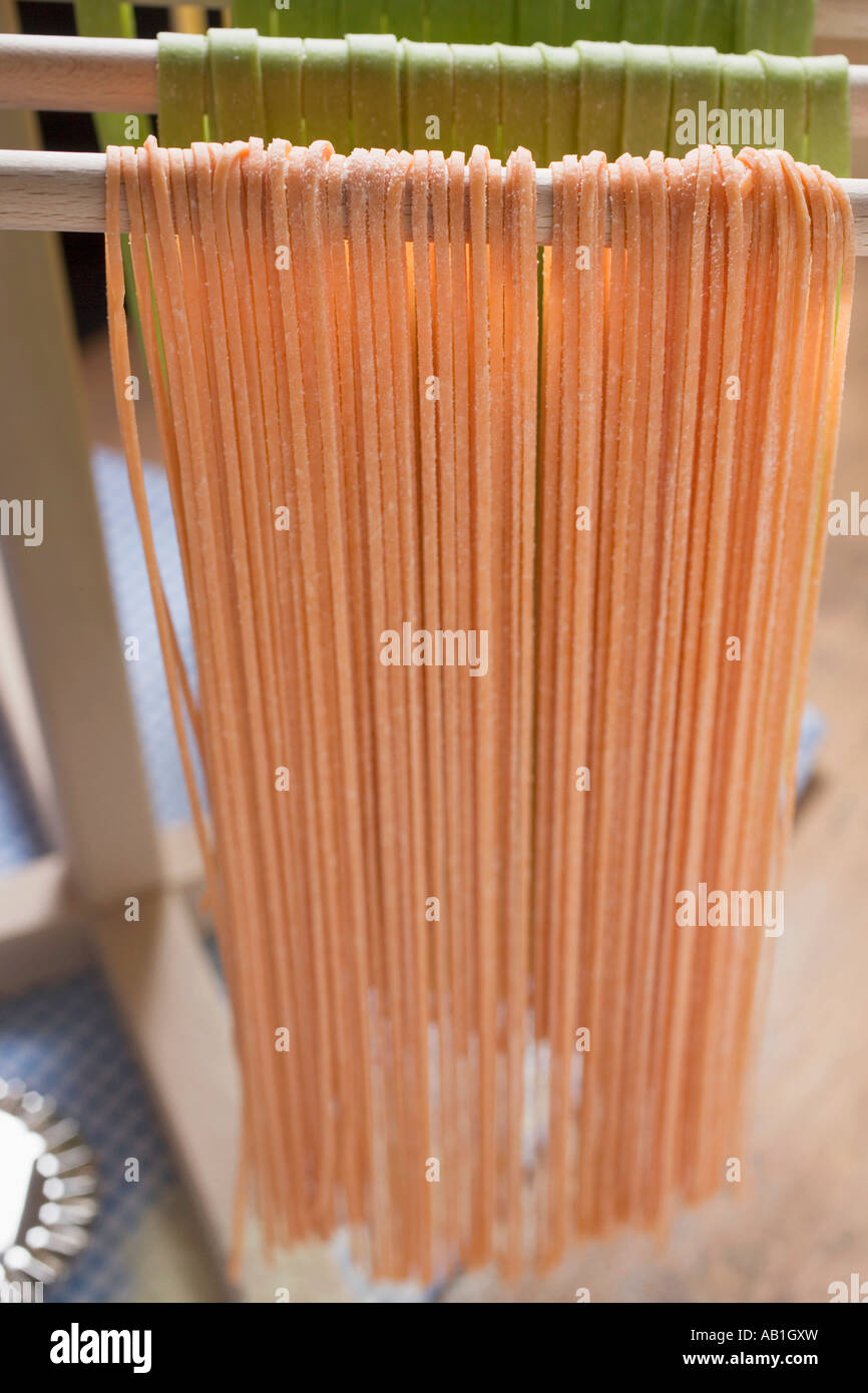 Home made red pasta hanging up to dry FoodCollection Stock Photo - Alamy