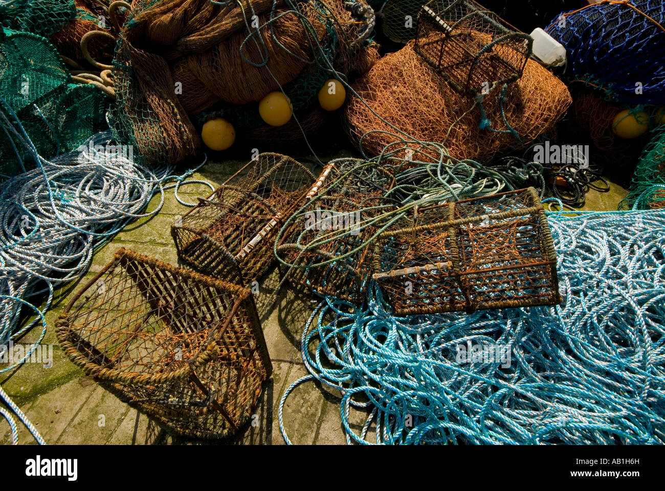 fishing nets and lobster creels stored on quayside Stock Photo - Alamy