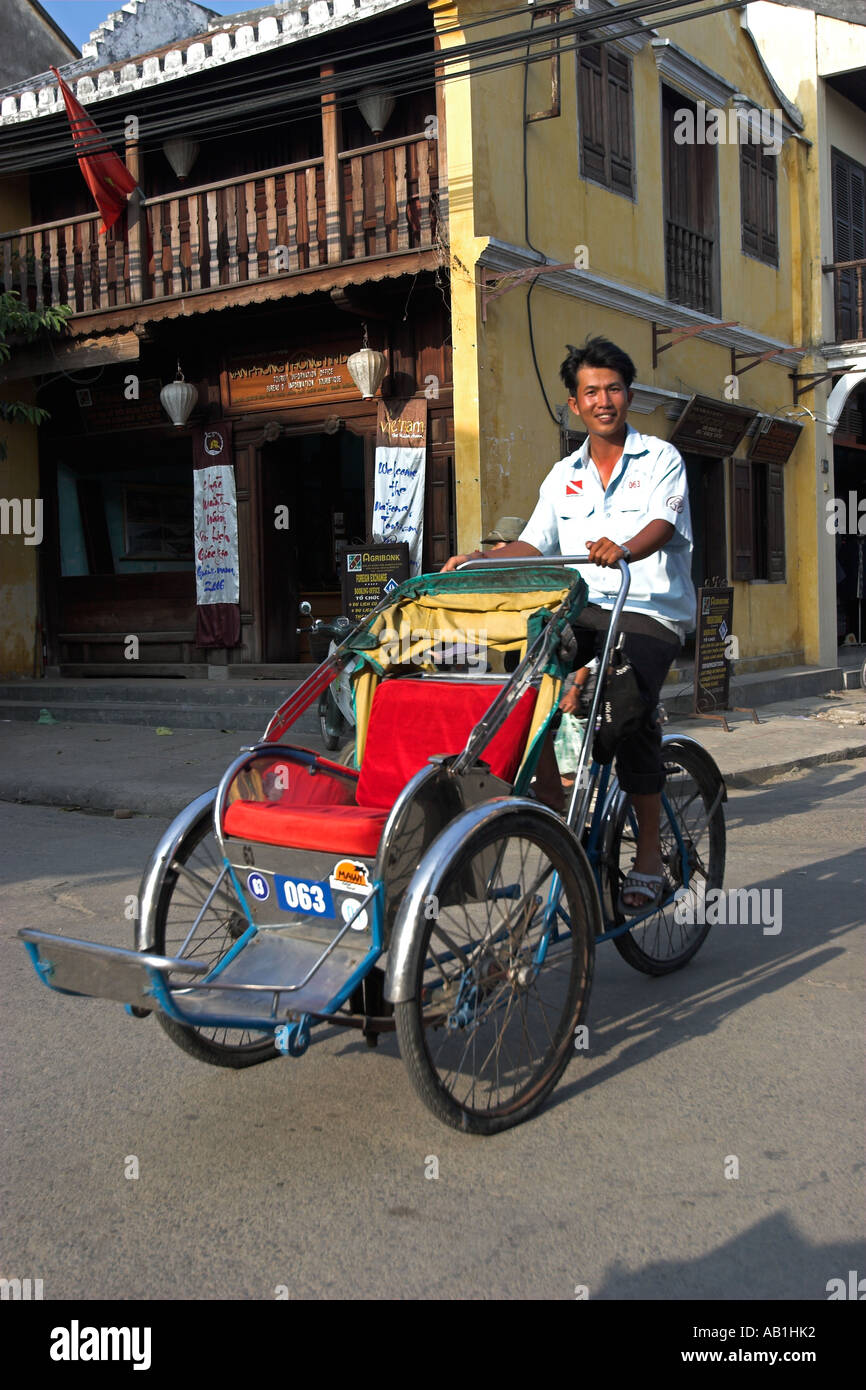 Cyclo rickshaw driver street corner Hoi An historic town mid Vietnam ...