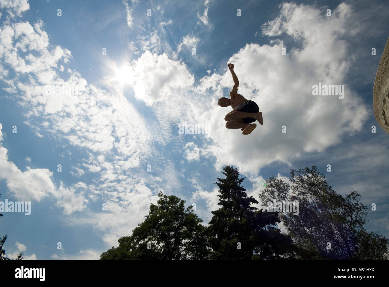 man leaping through the air into swimming pool Stock Photo - Alamy