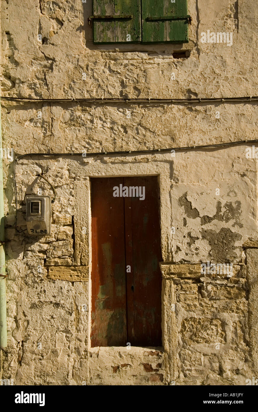 crumbling wall and shuttered windows in Paxos Island Greece Stock Photo ...