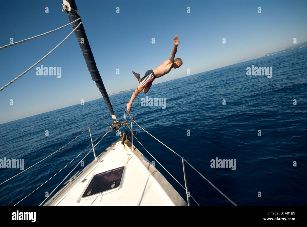 man diving off yacht into sea Stock Photo - Alamy