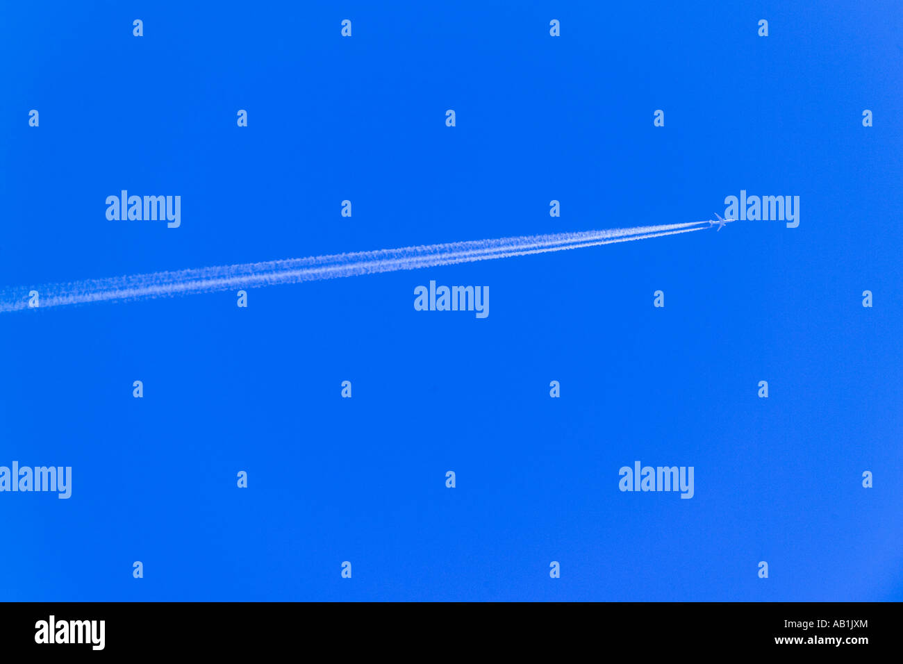 blue sky with high flying jet aircraft with vapour trail Stock Photo ...