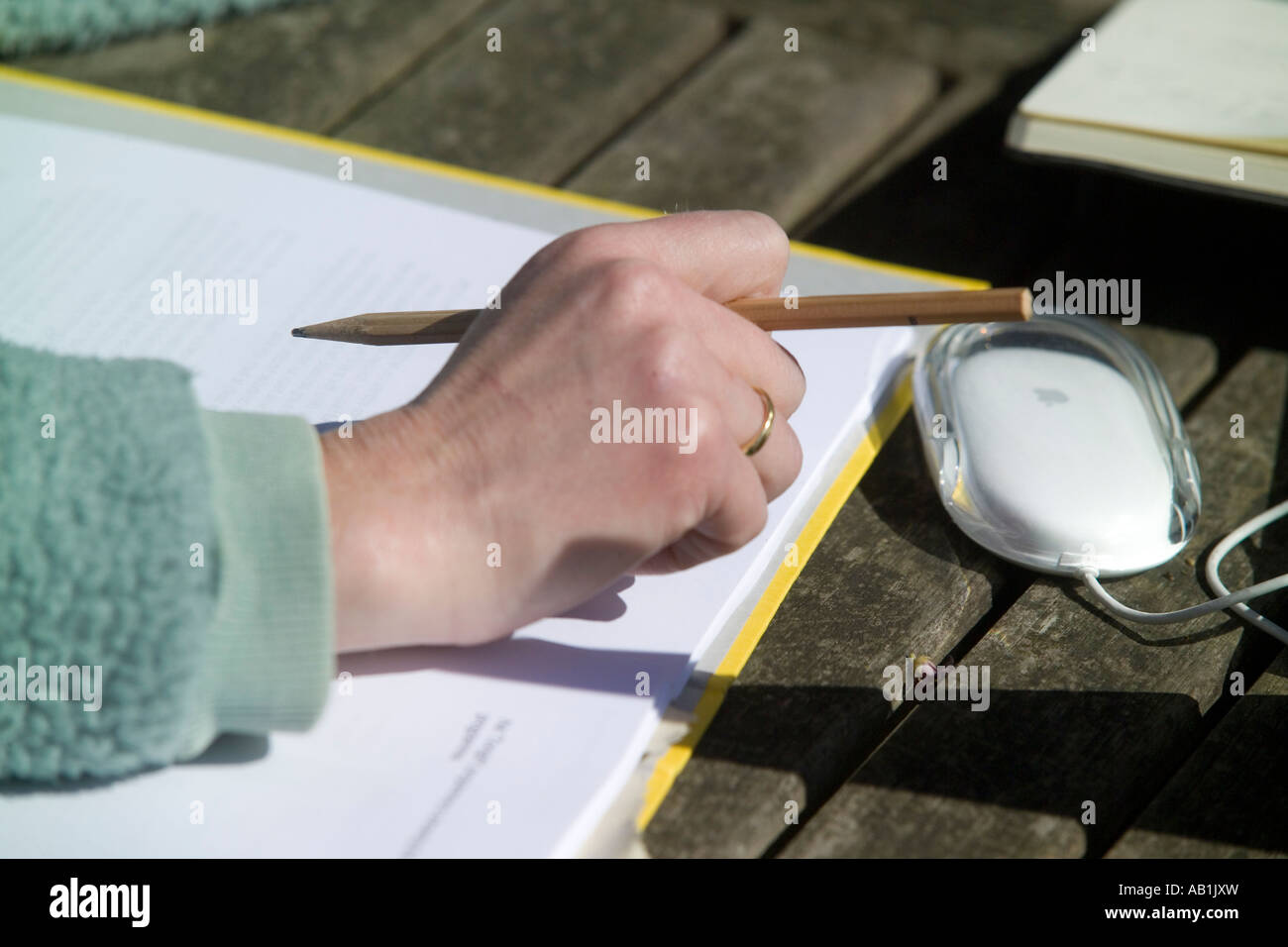 hand holding pencil next to mouse and drawing pad Stock Photo - Alamy