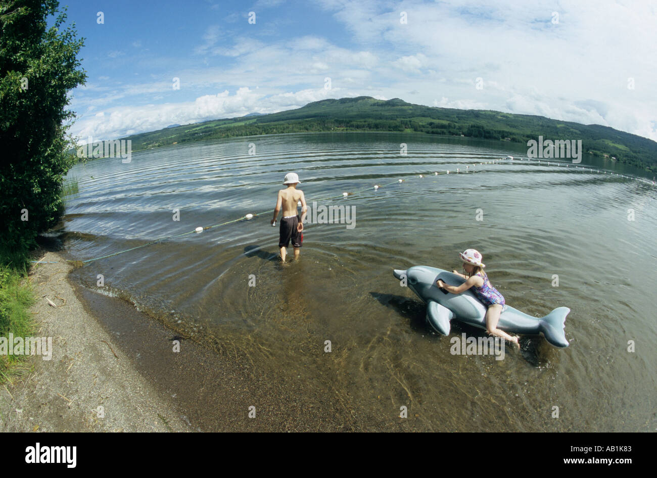Children playing in lake Tyhee Lake provincial Park Telkwa British ...