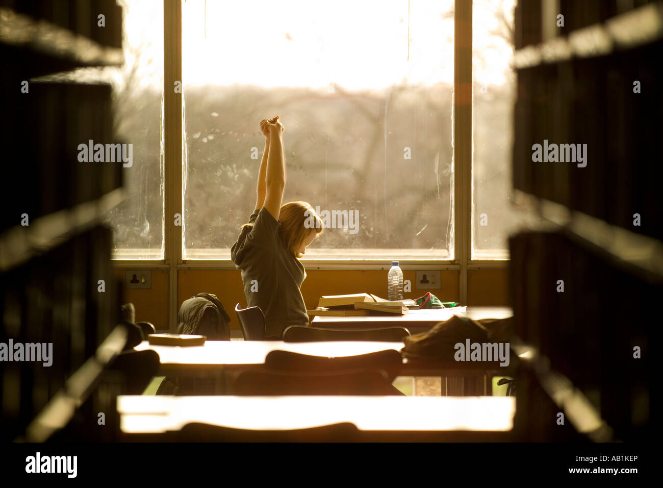student stretching during studying in library Stock Photo - Alamy