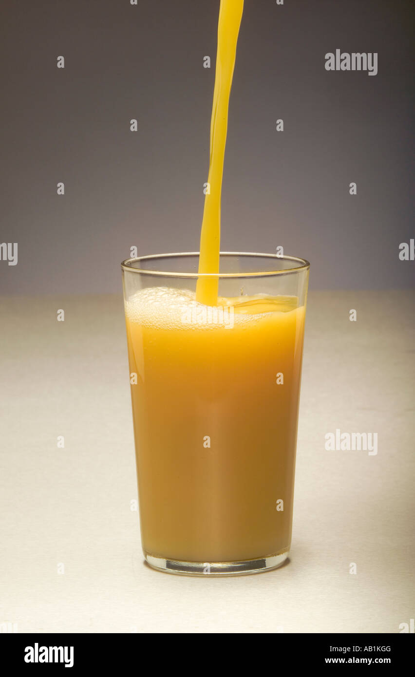 glass of orange juice being poured Stock Photo - Alamy