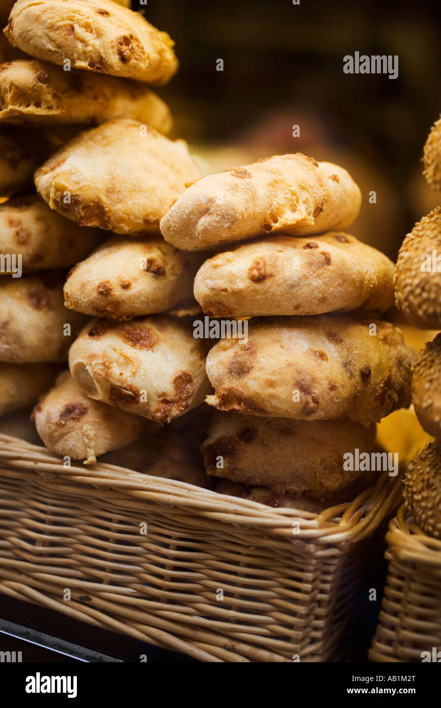 Various types of bread rolls in baskets at a market FoodCollection ...