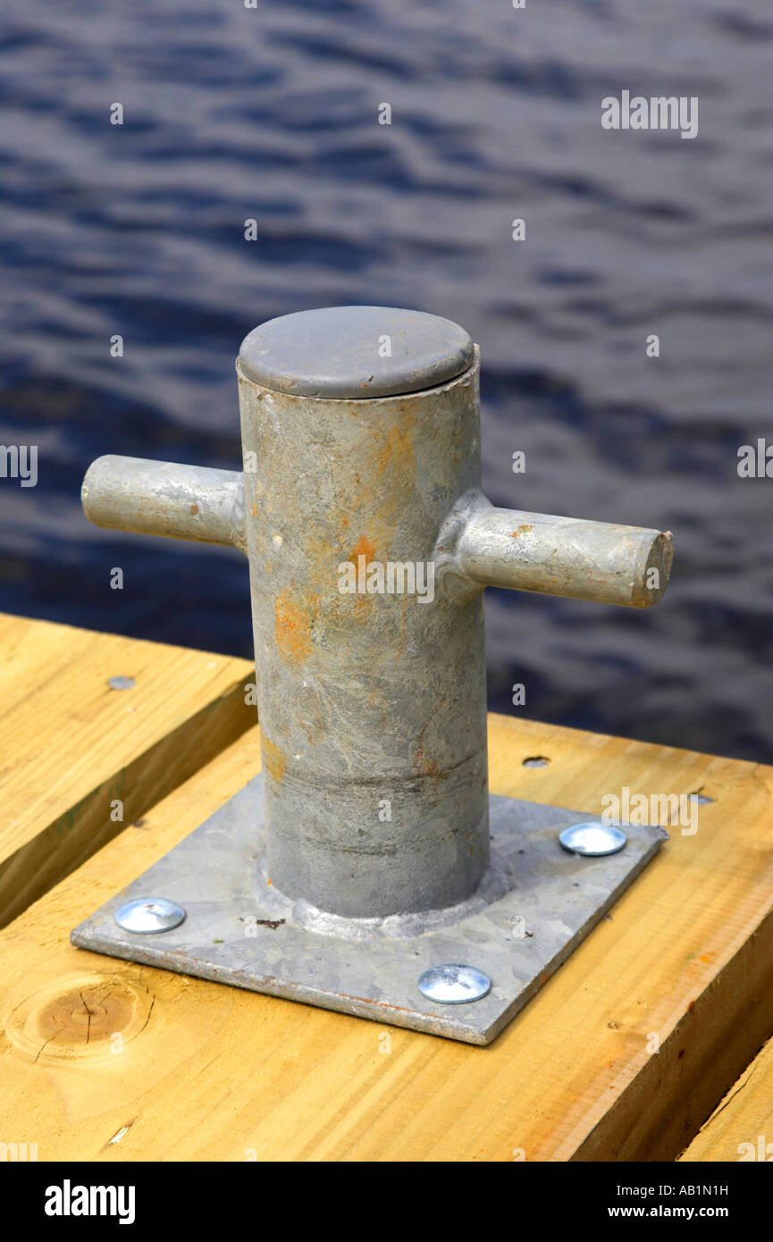 vertical close up new metal mooring post secured to wooden jetty ...