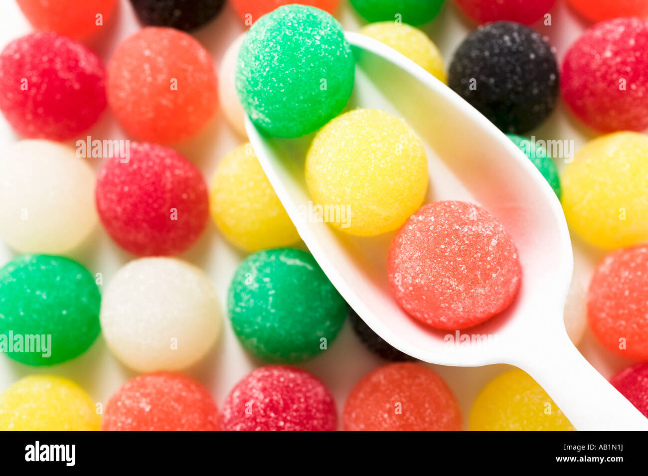 Coloured jelly sweets in rows with scoop close up FoodCollection Stock ...
