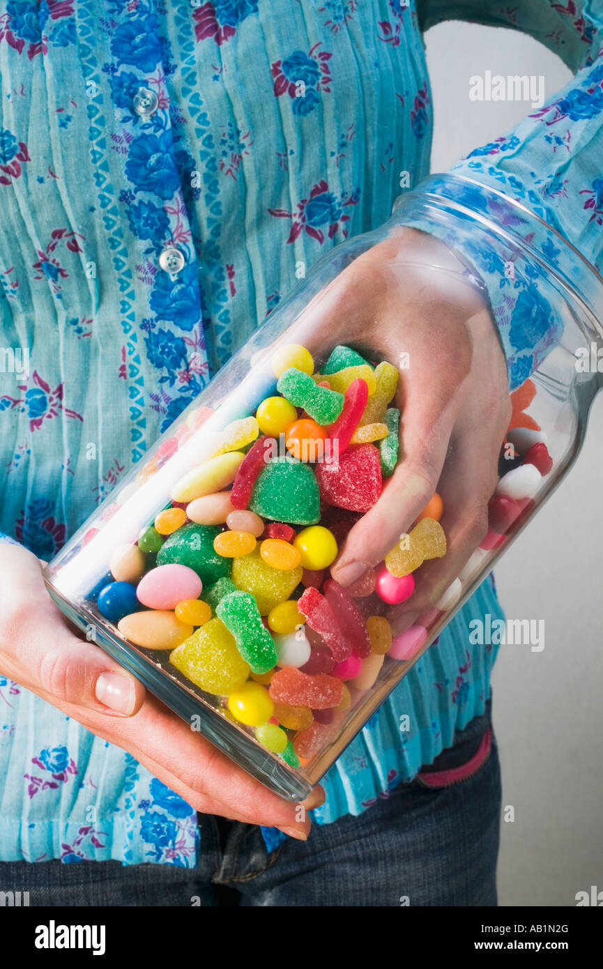Hand taking sweets out of jar FoodCollection Stock Photo - Alamy