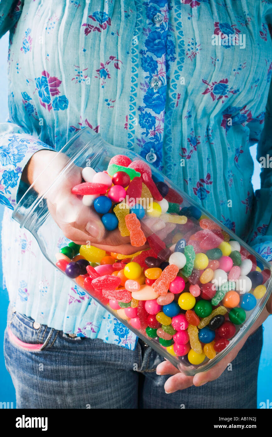 Hand taking sweets out of jar FoodCollection Stock Photo - Alamy