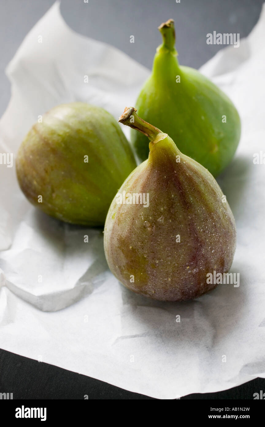 Three figs on paper FoodCollection Stock Photo - Alamy