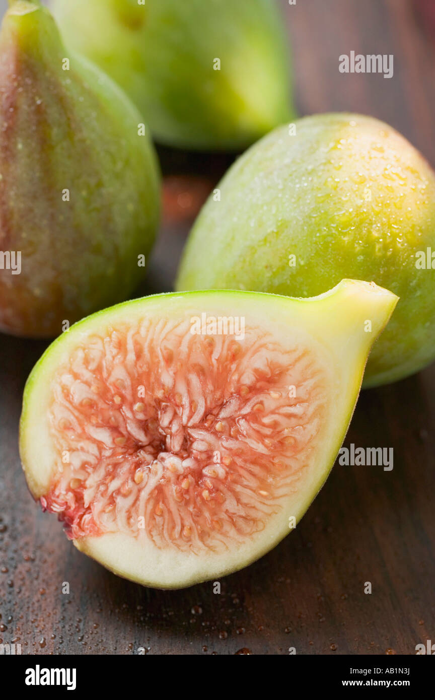 Three whole figs and one half fig close up FoodCollection Stock Photo ...