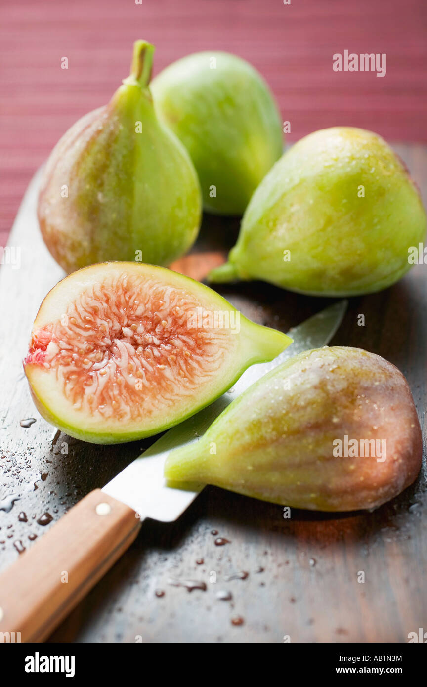 Three whole figs and two fig halves with knife FoodCollection Stock ...