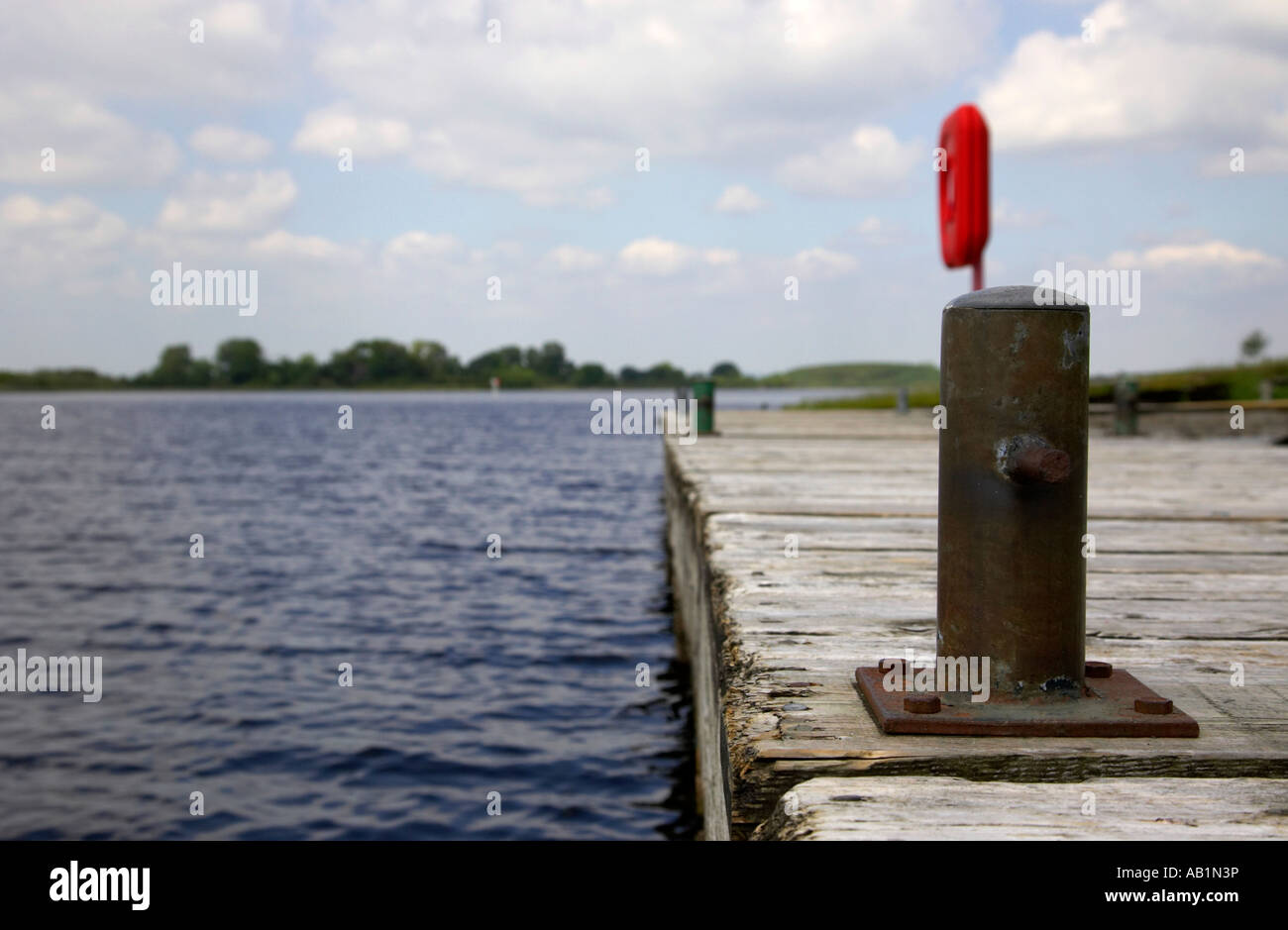 old metal boat mooring post attached to old worn wooden planks on ...