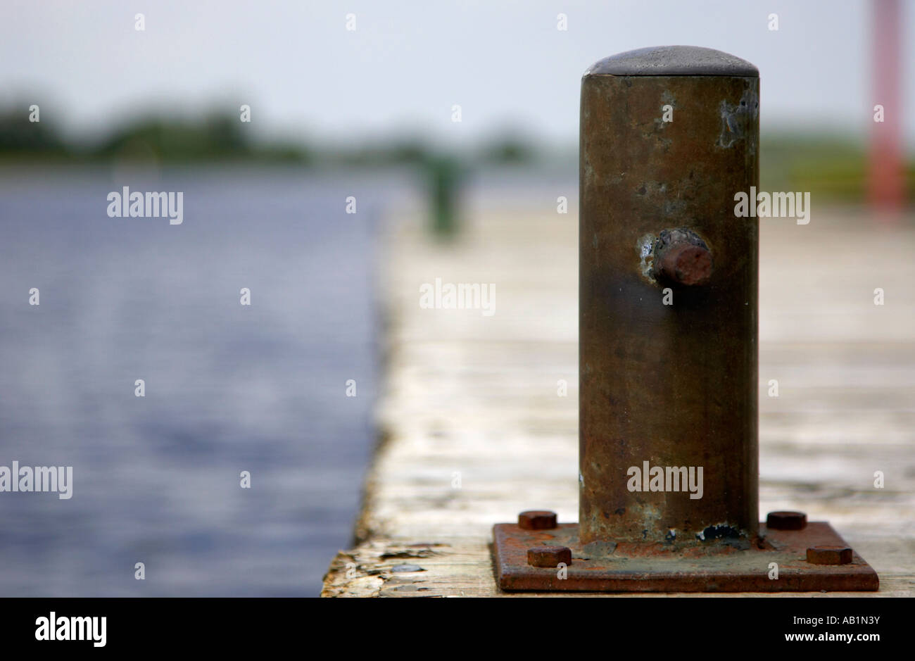 old metal boat mooring post attached to old worn wooden planks on ...