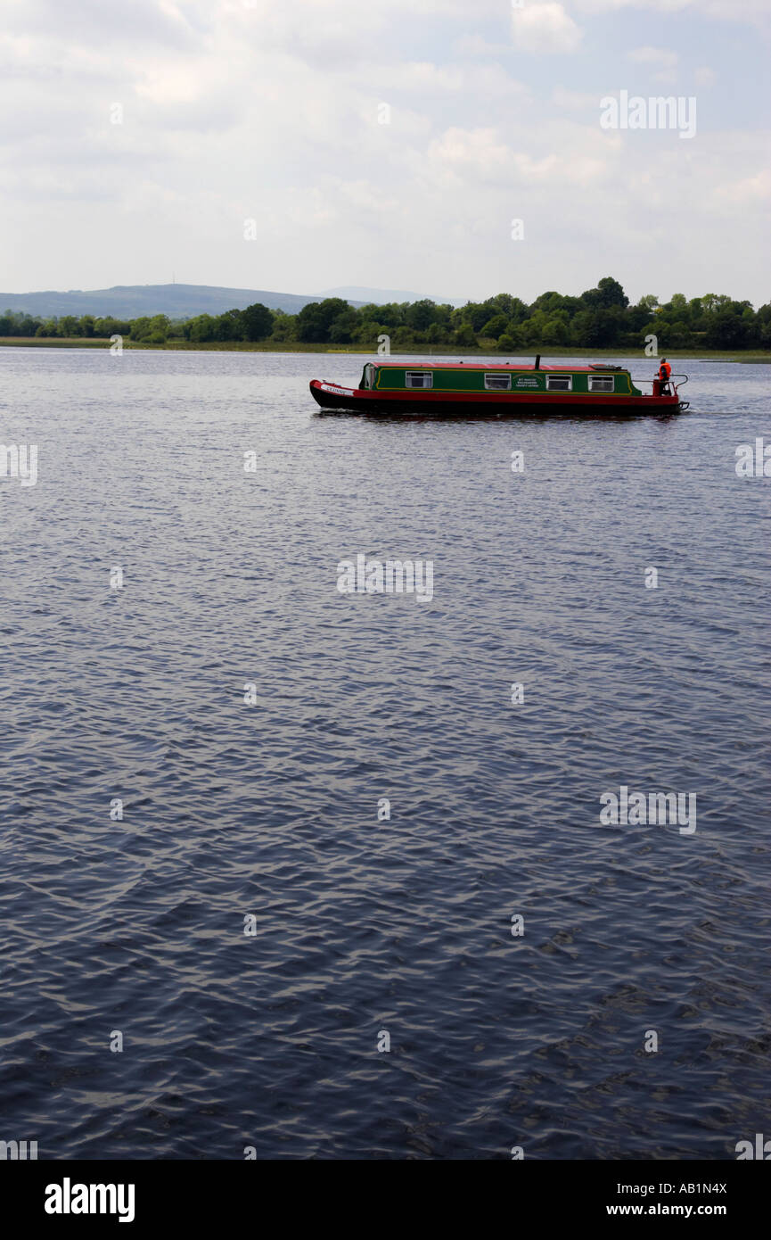 tourist steering narrowboat barge along lower lough erne vertical Stock ...