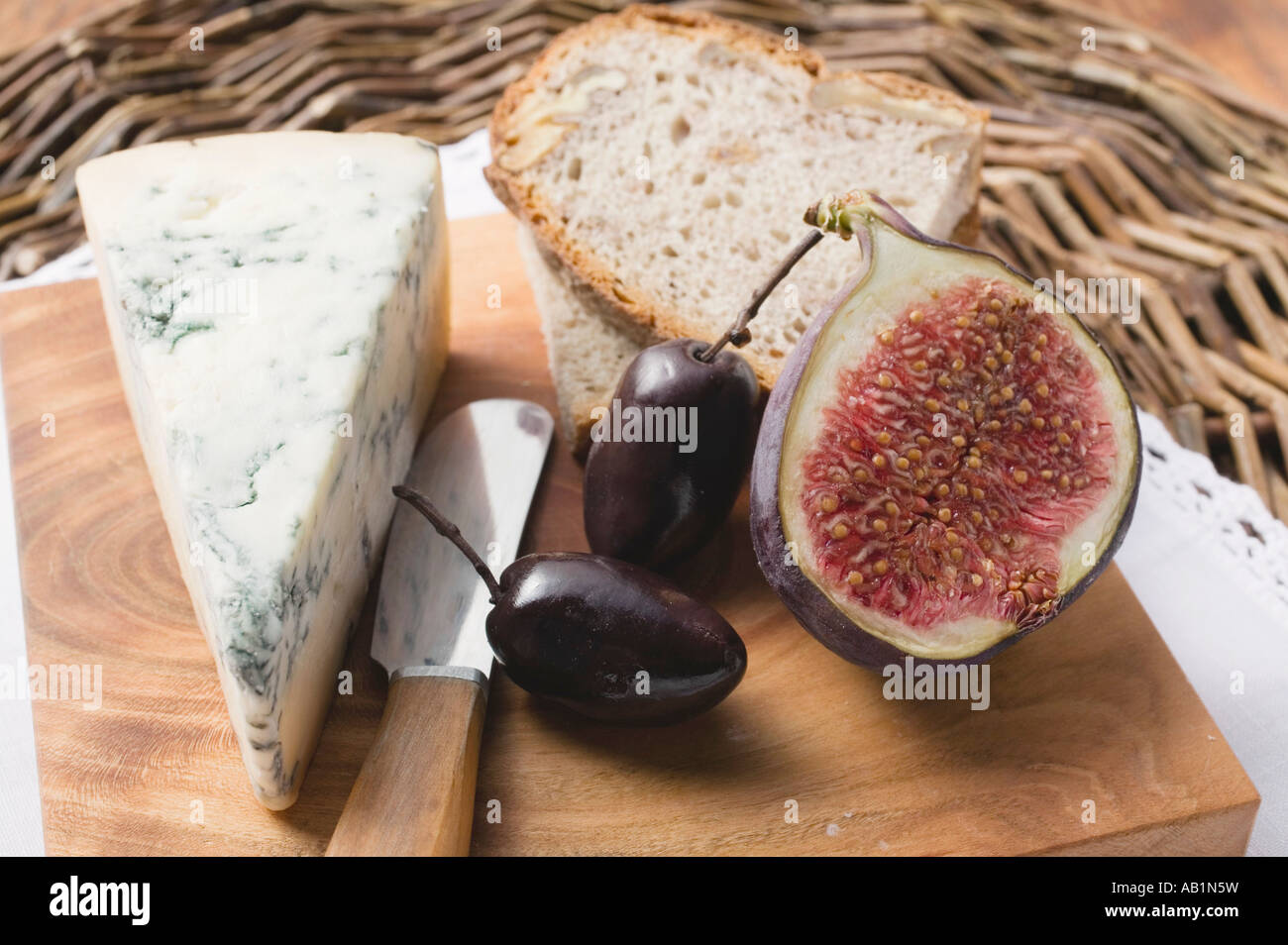 Piece of blue cheese half a fig olives and bread FoodCollection Stock ...