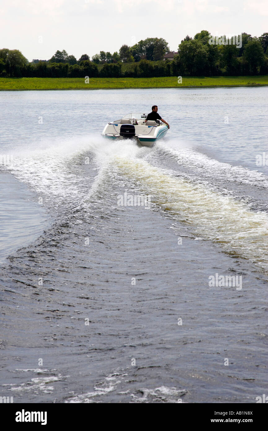 vertical of wake behind man driving speedboat in lower lough erne ...