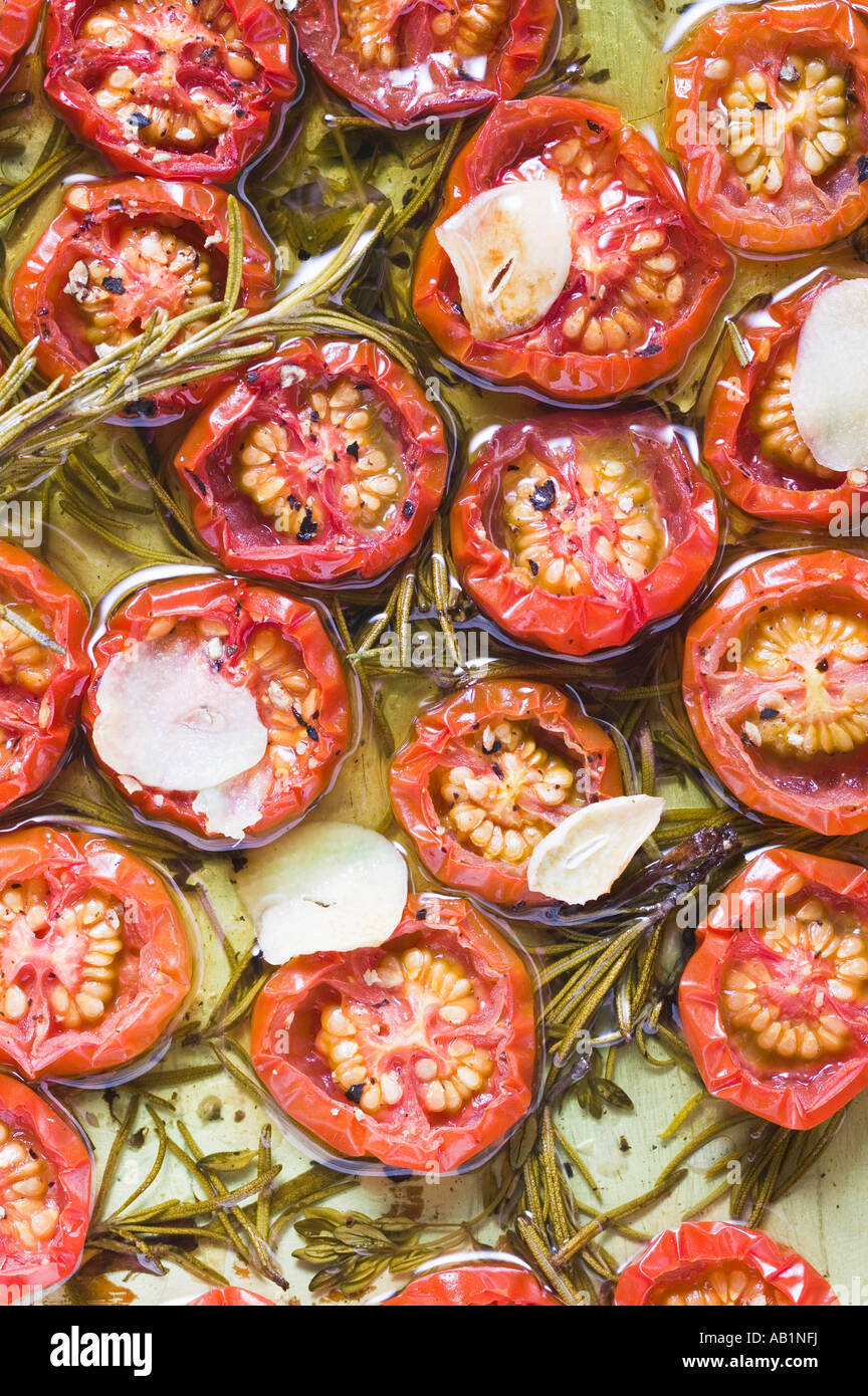 Tomatoes in olive oil with garlic and rosemary FoodCollection Stock ...