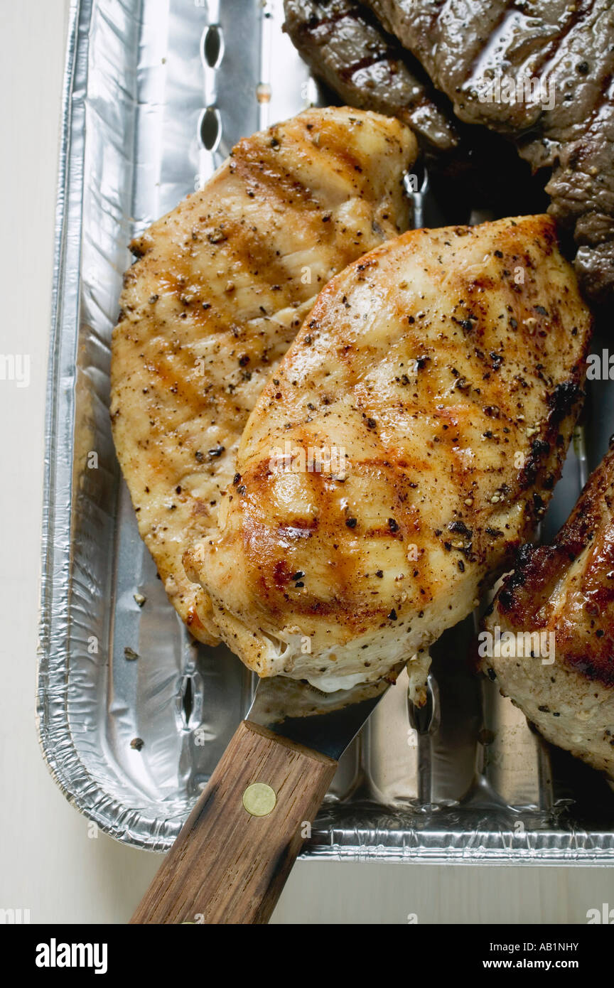 Grilled meat in aluminium grill tray overhead view FoodCollection Stock ...