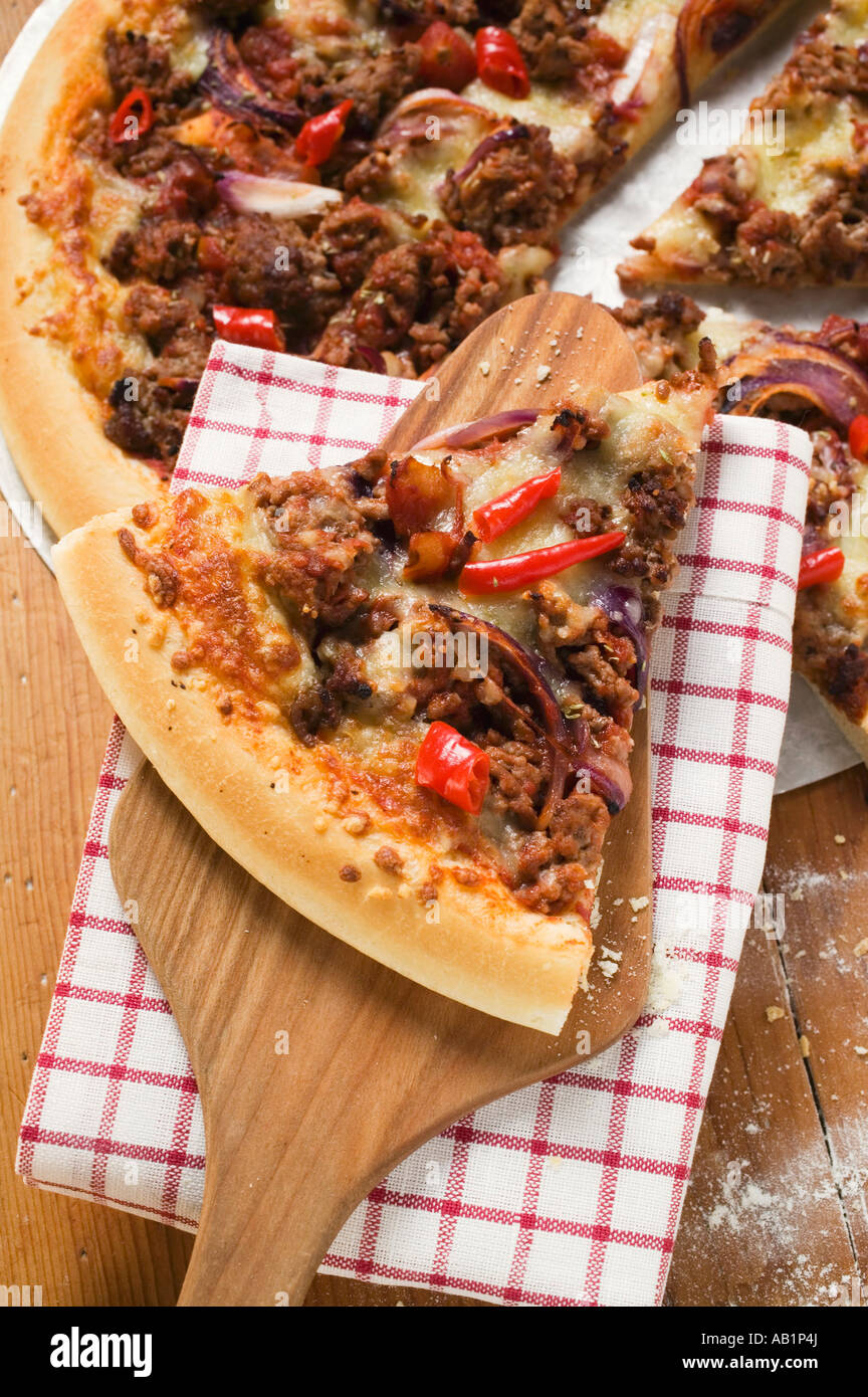 Mince and onion pizza partly sliced FoodCollection Stock Photo - Alamy