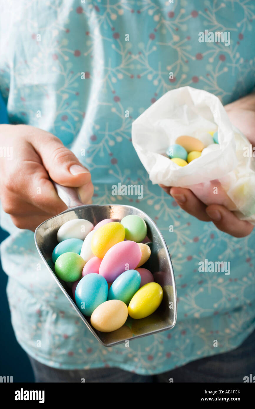 Hands holding scoop full of sugared almonds FoodCollection Stock Photo ...
